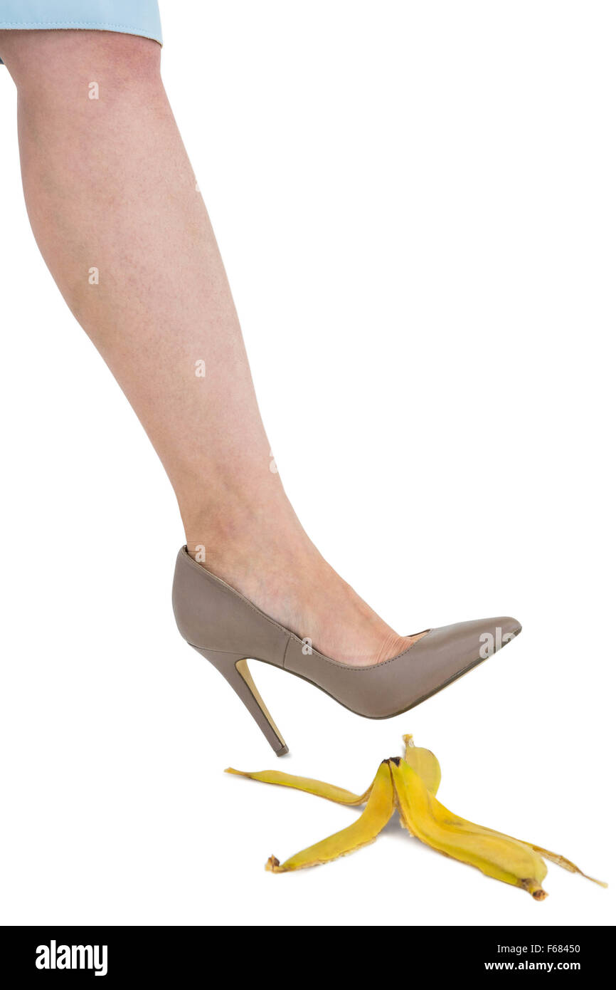 Cropped image of businesswoman crushing banana skin Stock Photo - Alamy