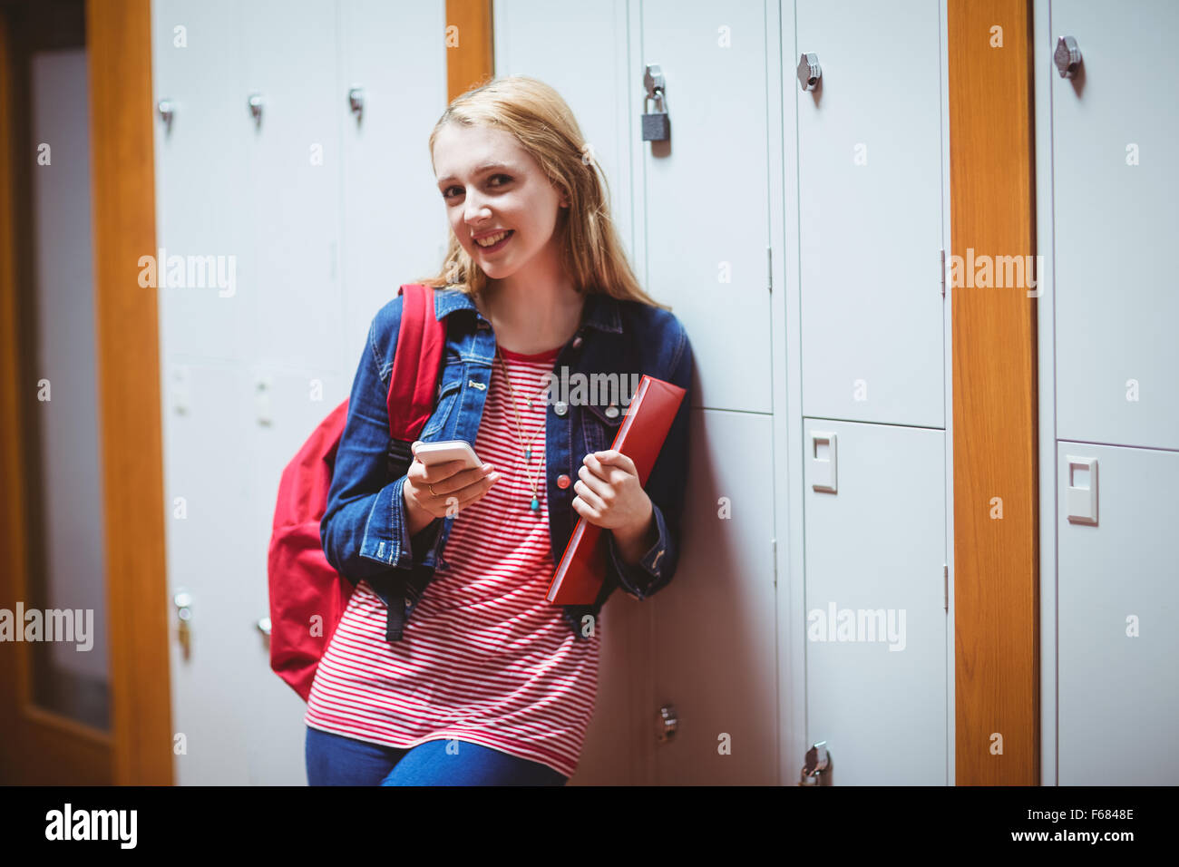 Smiling student leaning against locker hi-res stock photography and ...