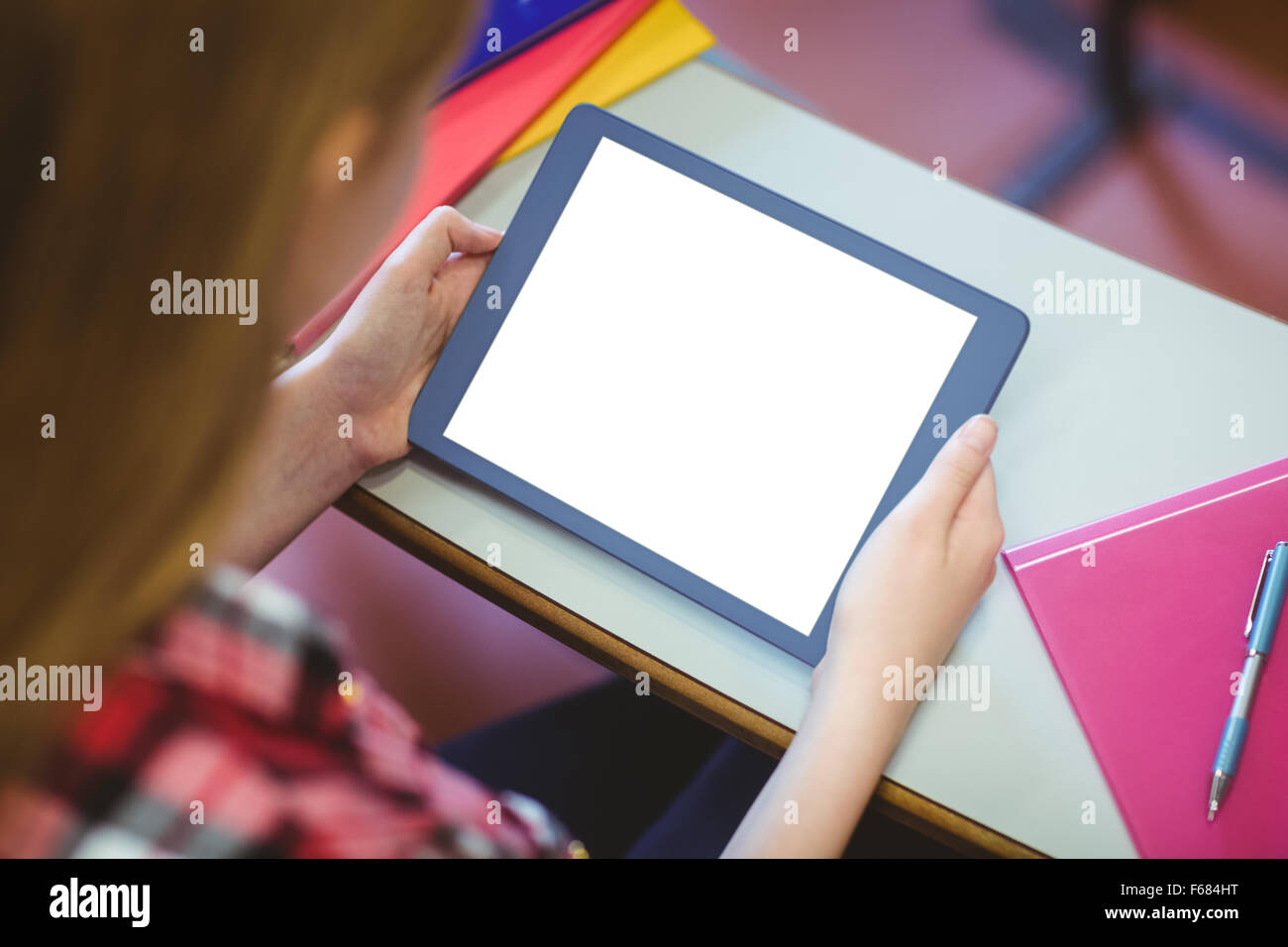Blonde student using tablet during class Stock Photo - Alamy