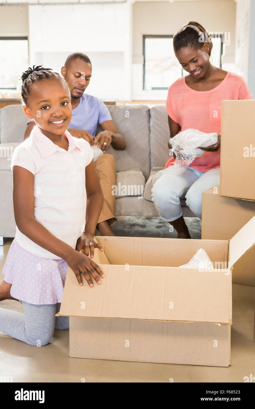 Family unwrapping things in new home Stock Photo - Alamy