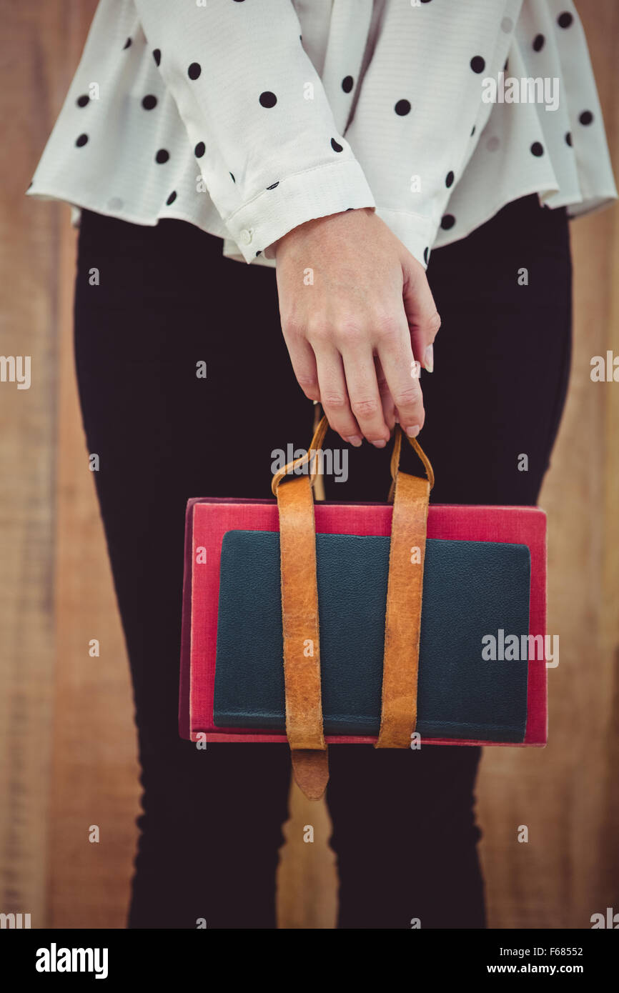 Cropped image of woman holding book belt Stock Photo - Alamy