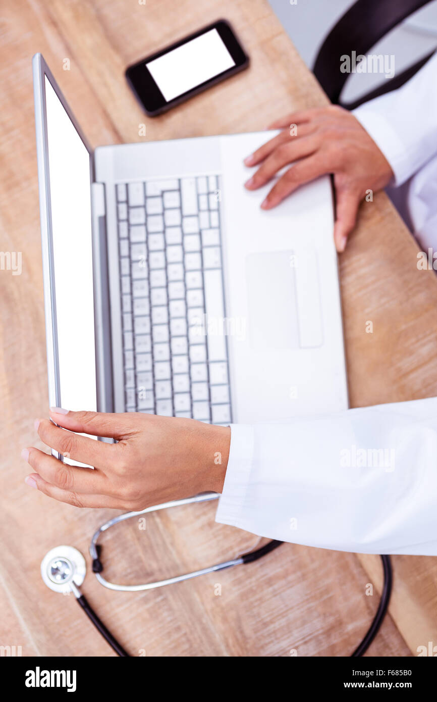 Doctor using smartphone laptop hi-res stock photography and images - Alamy