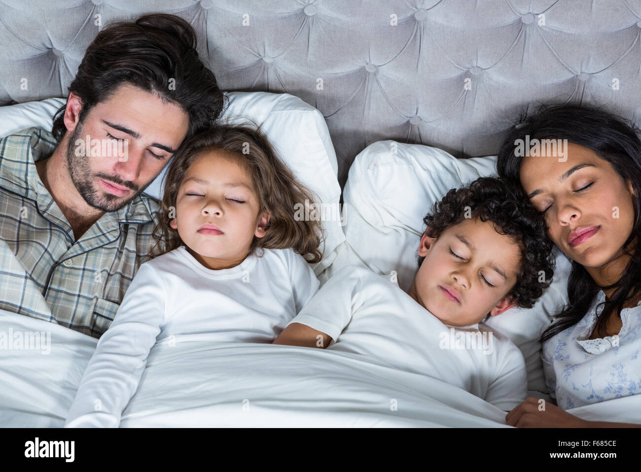 Happy family sleeping together Stock Photo - Alamy
