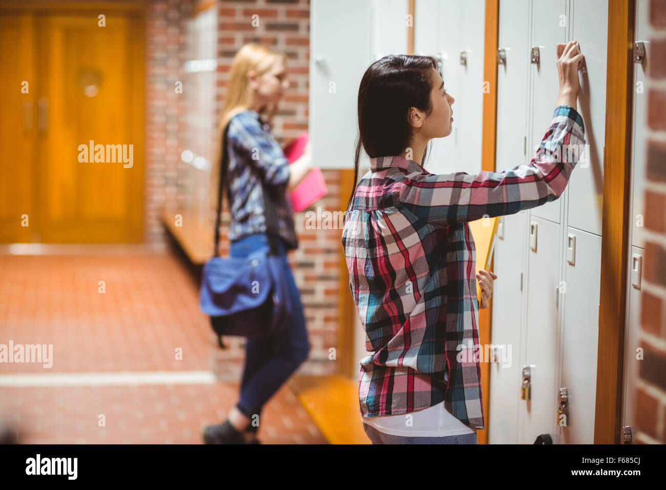 Pretty students opening lockers Stock Photo - Alamy