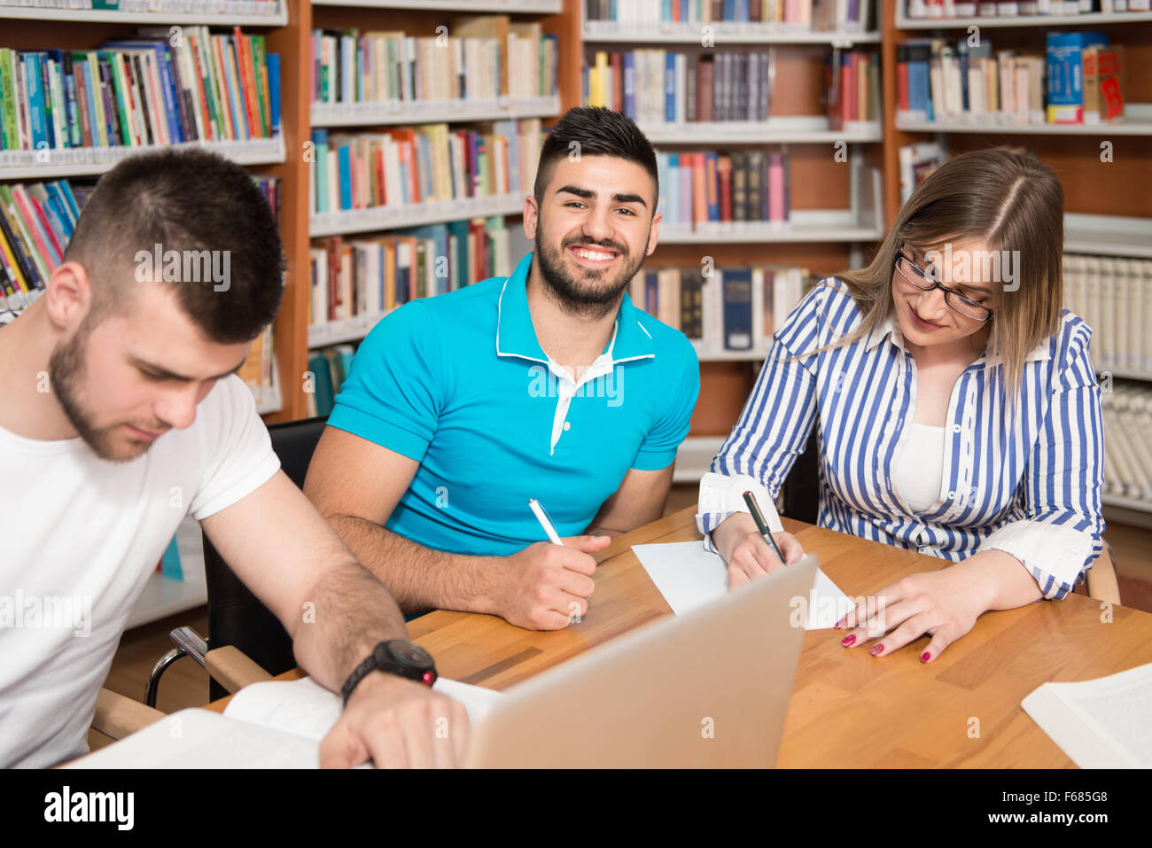 In The Library - Handsome Group Of Students With Laptop And Books ...