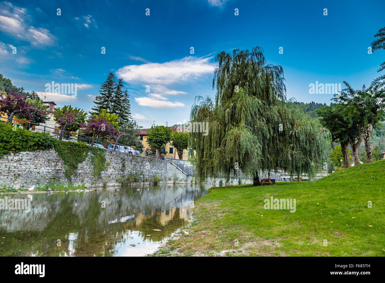 River runs thorugh medieval mountain village in Tuscany characterized ...