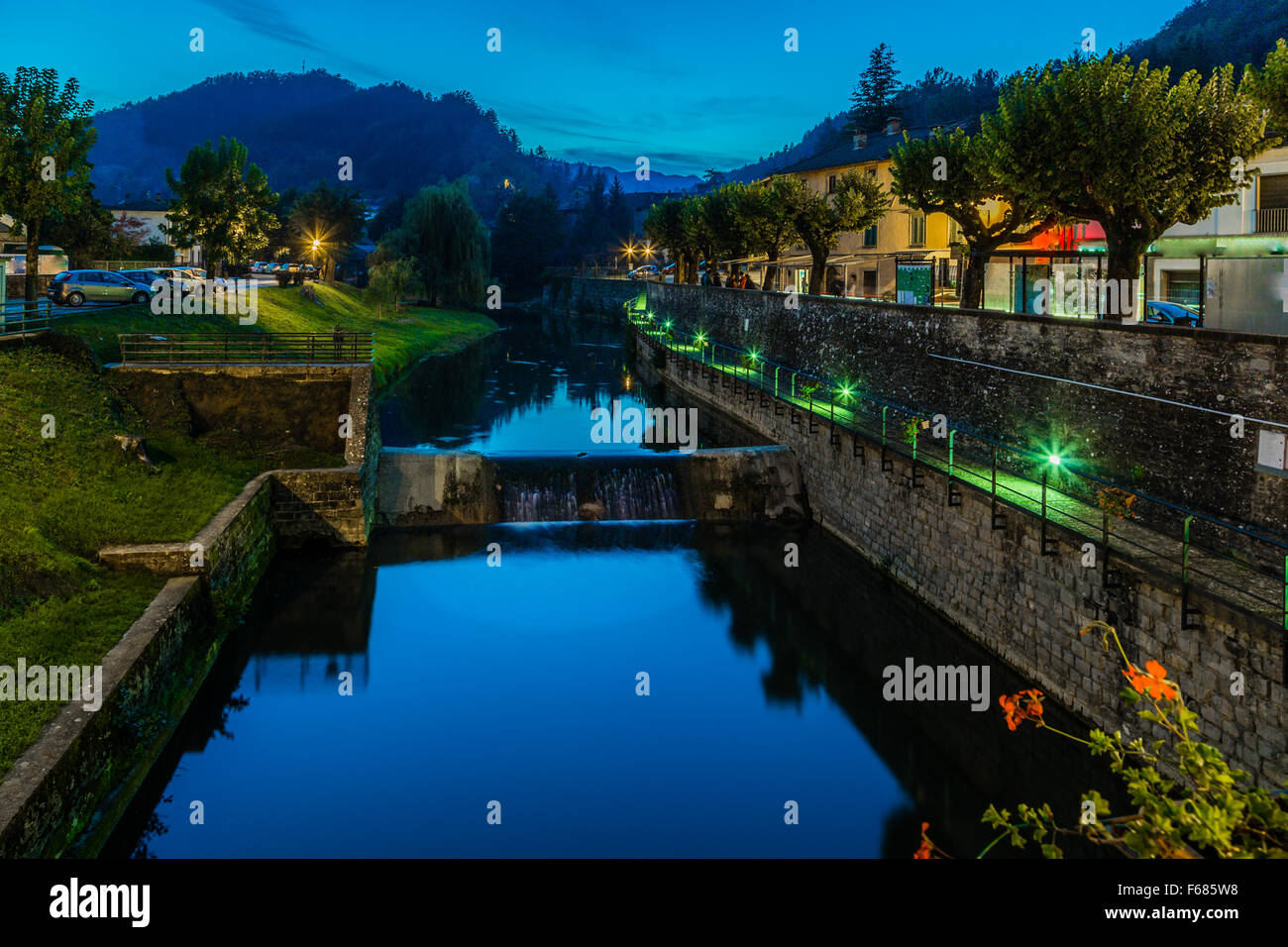 River runs thorugh medieval mountain village in Tuscany characterized ...