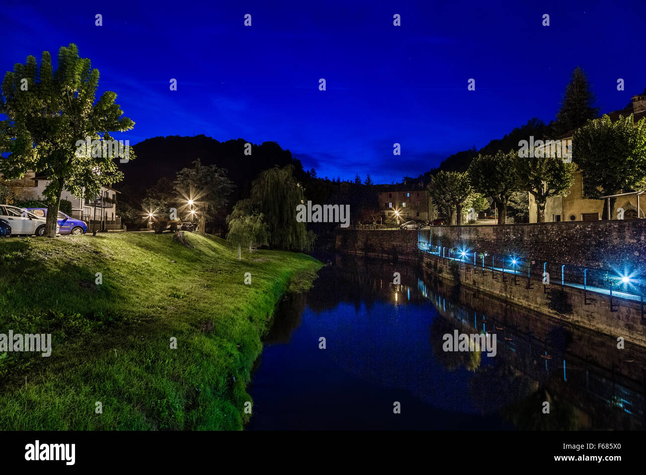 River runs thorugh medieval mountain village in Tuscany characterized ...