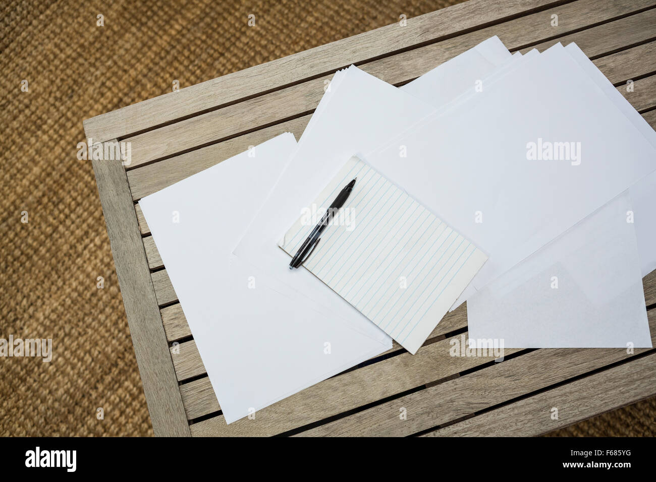 Papers on wooden table Stock Photo - Alamy
