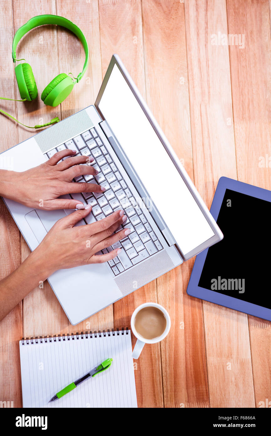Overhead of feminine hands typing on laptop Stock Photo - Alamy