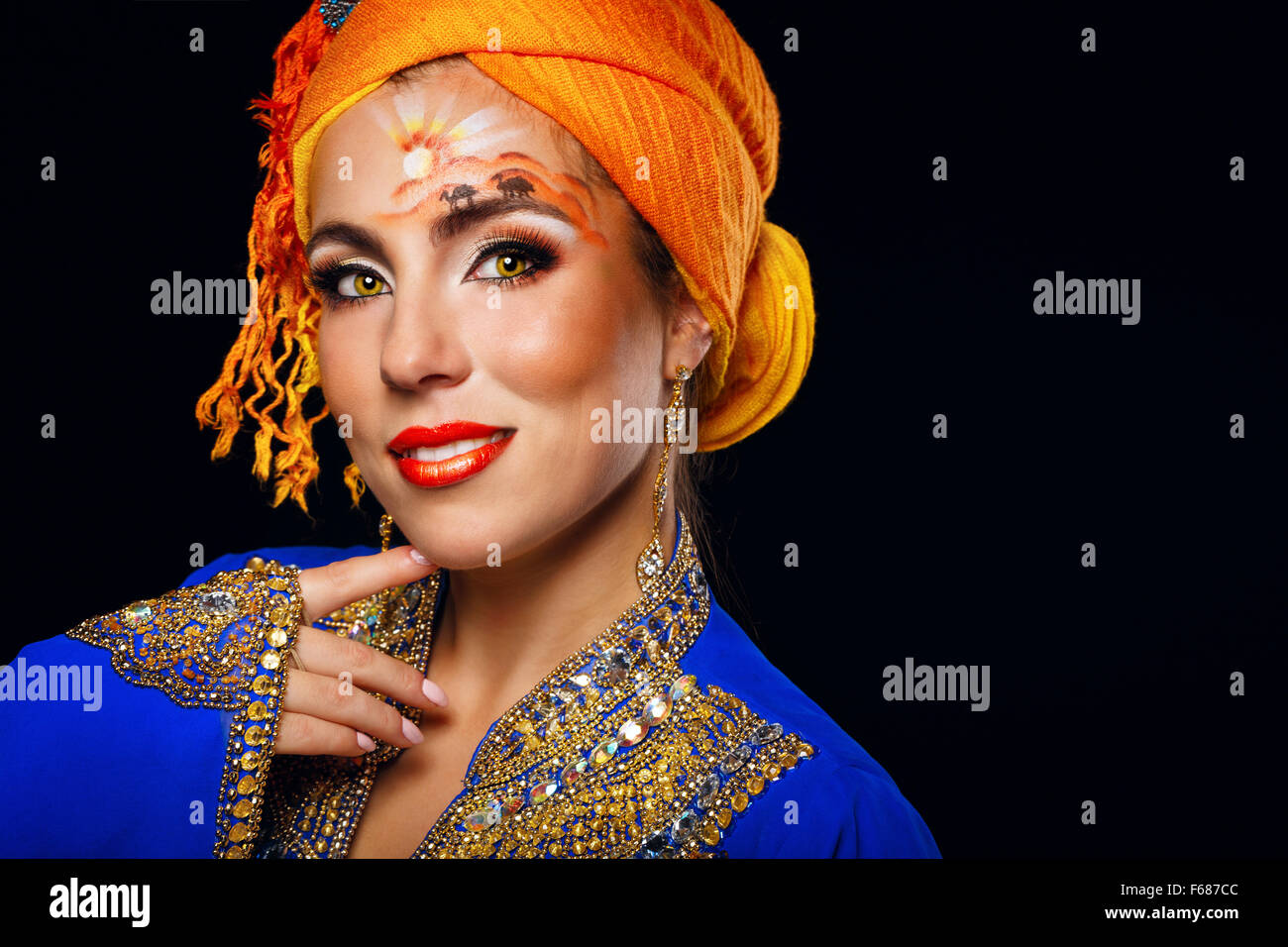 Portrait of eastern beauty with face art and national costumes. Girl ...