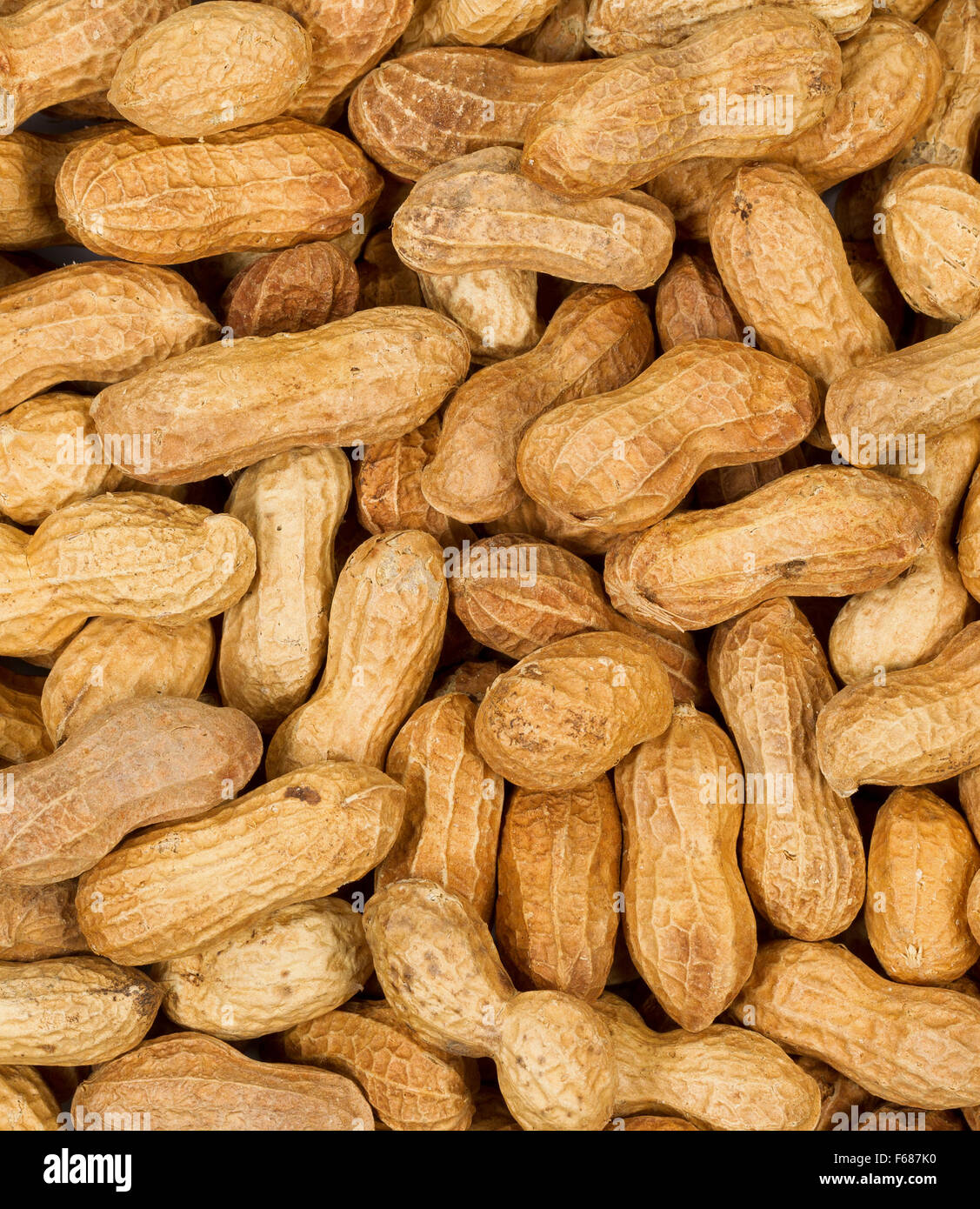 Close up of raw, unshelled dried peanuts in filled frame layout Stock ...