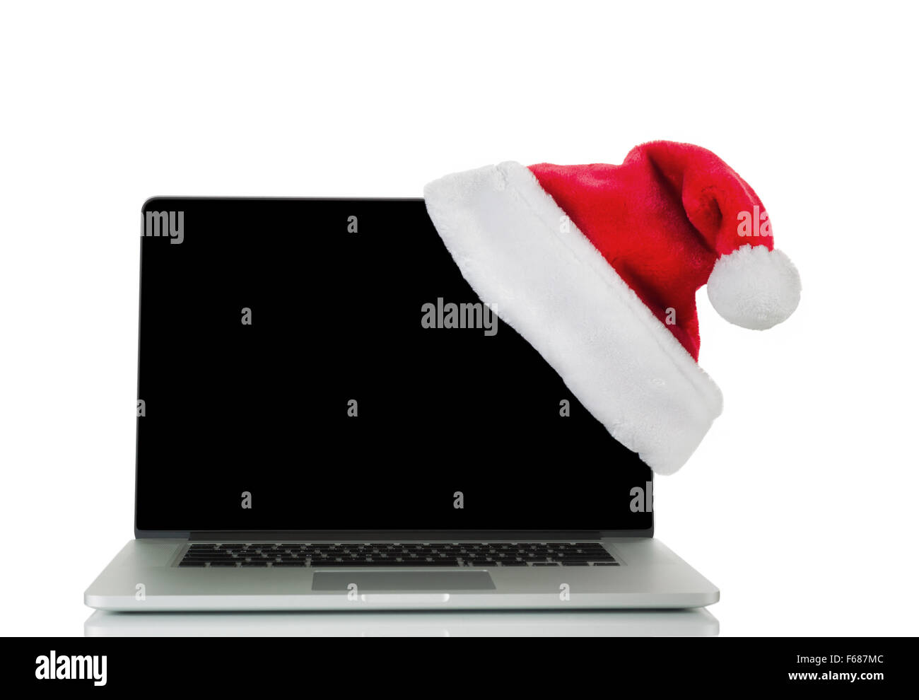 Traditional Christmas Santa Cap and laptop computer isolated on white ...