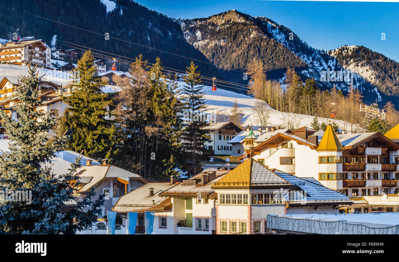 The roofs of a people friendly alpine town in the background of snowy ...