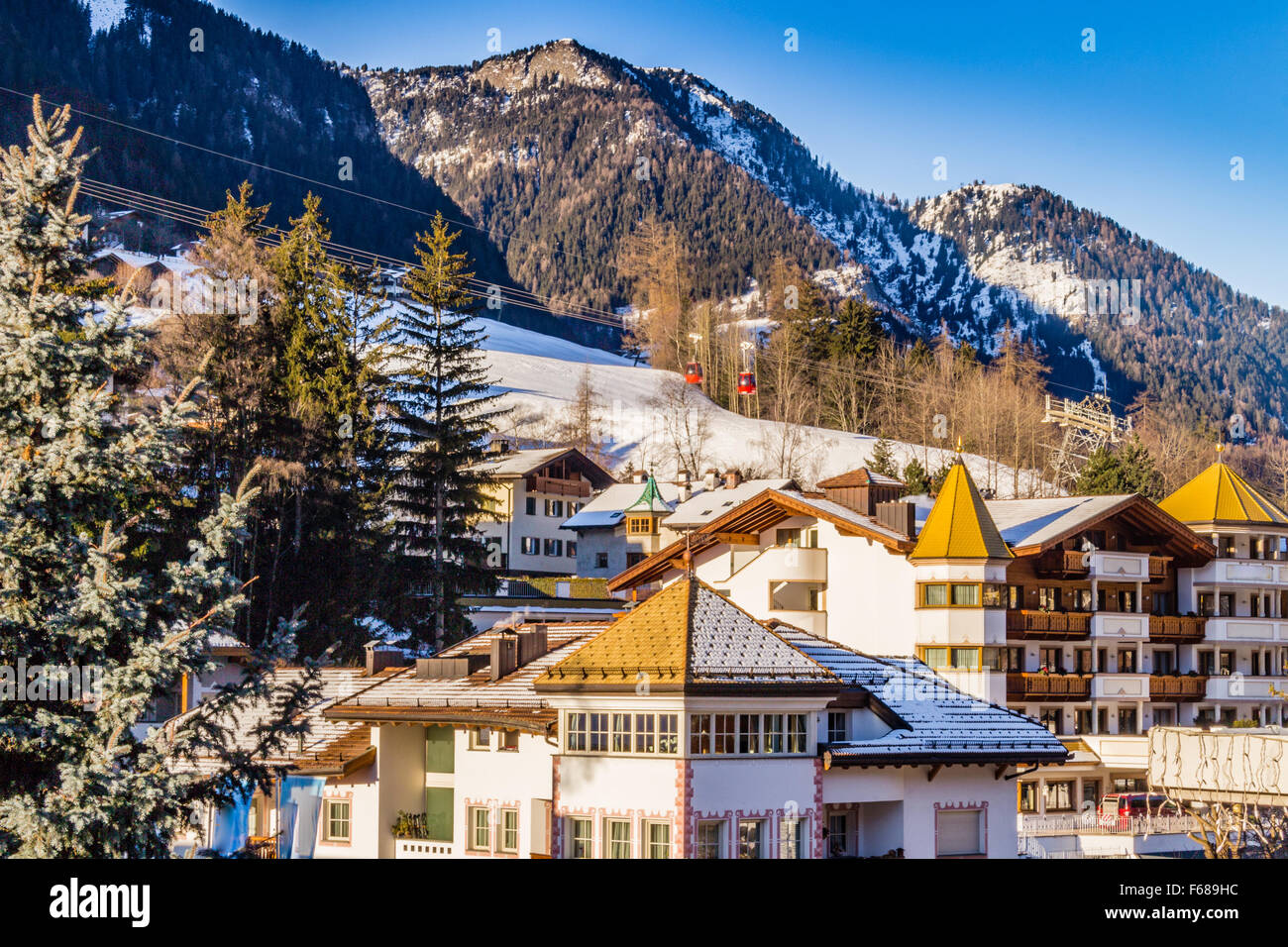 The roofs of a people friendly alpine town in the background of snowy ...