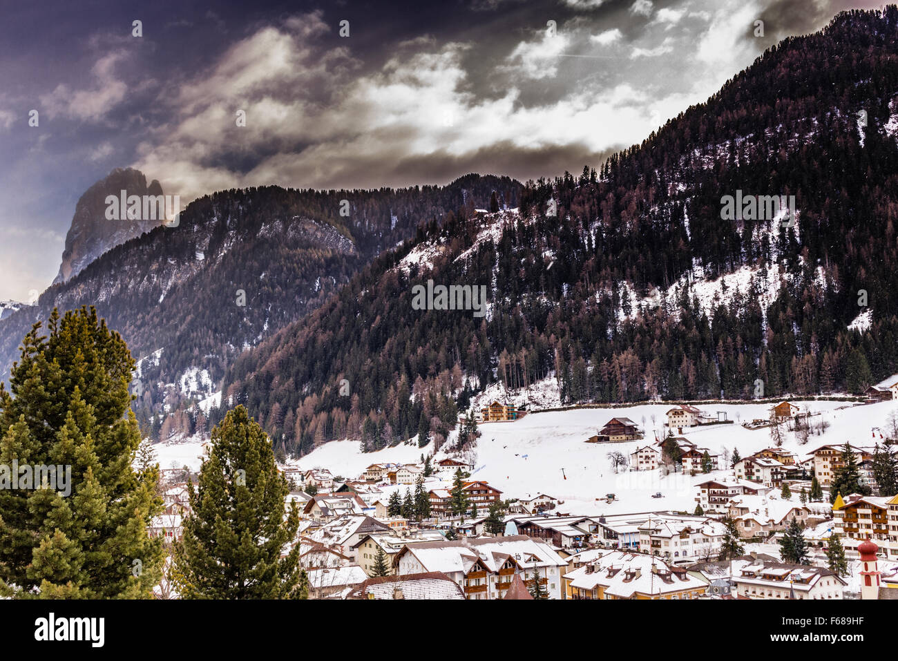 The roofs of a people friendly alpine town in the background of snowy ...