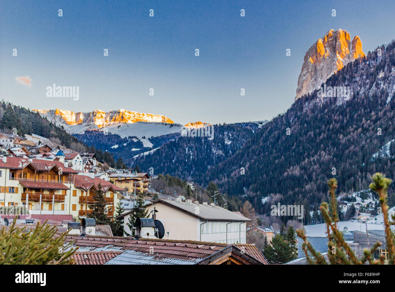 The roofs of a people friendly alpine town in the background of snowy ...