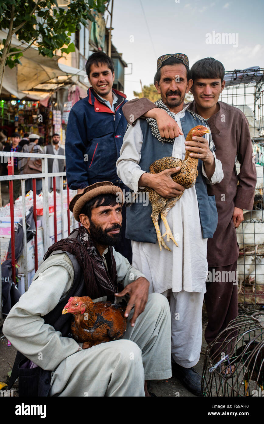 Men in traditional Afghan clothes selling domestic birds at Ka Farushi ...