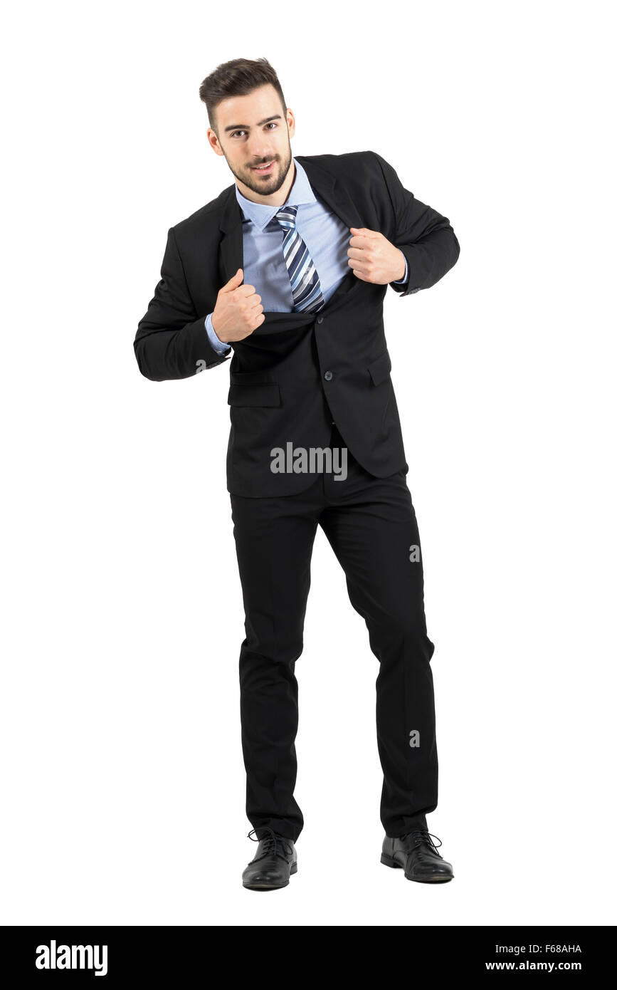 Young happy businessman pulling and stretching his suit jacket smiling ...