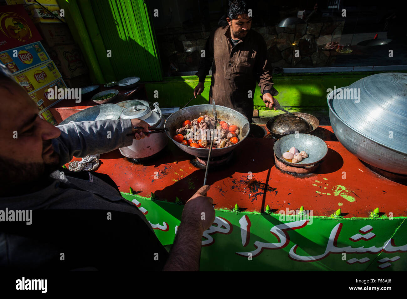Traditional restaurant serving kebab, prepared at open oven with wooden ...