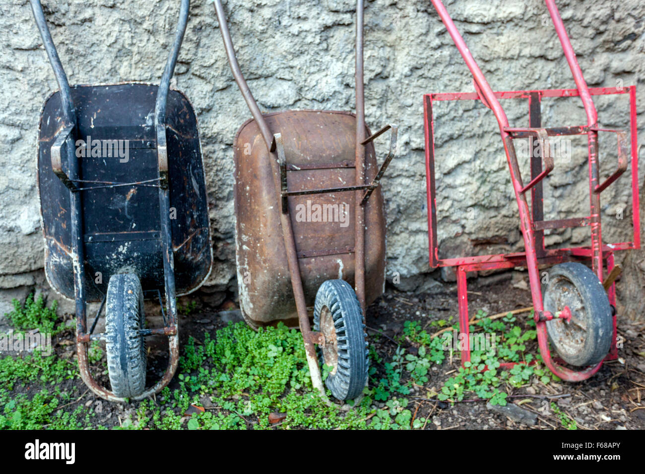 Three garden wheelbarrows leaning against the wall Wheelbarrow garden ...