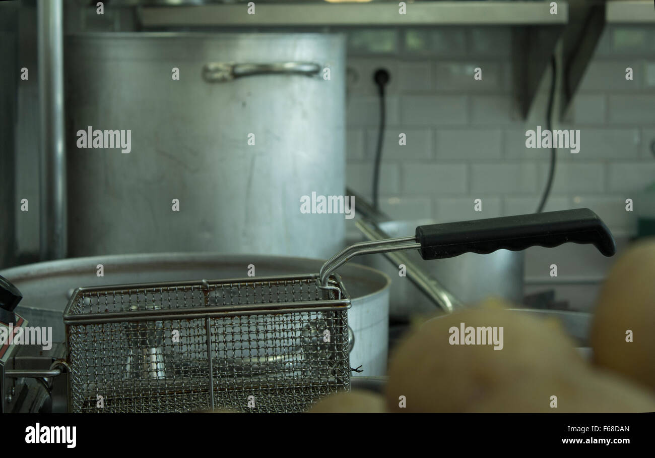 Deep fryer with boiling oil on fast food kitchen Stock Photo - Alamy