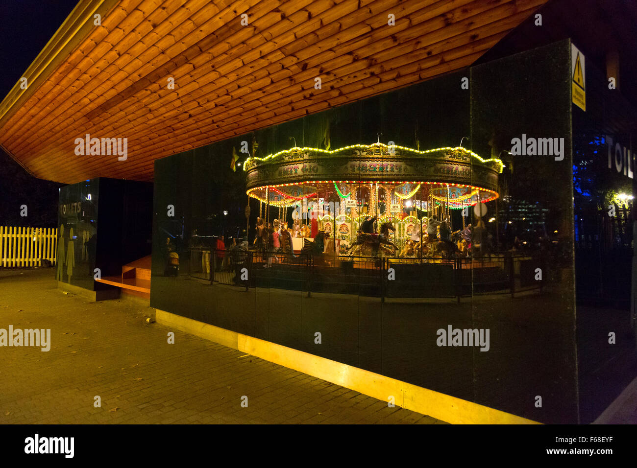 Carousel reflected in the windows of a building, South Bank, London ...