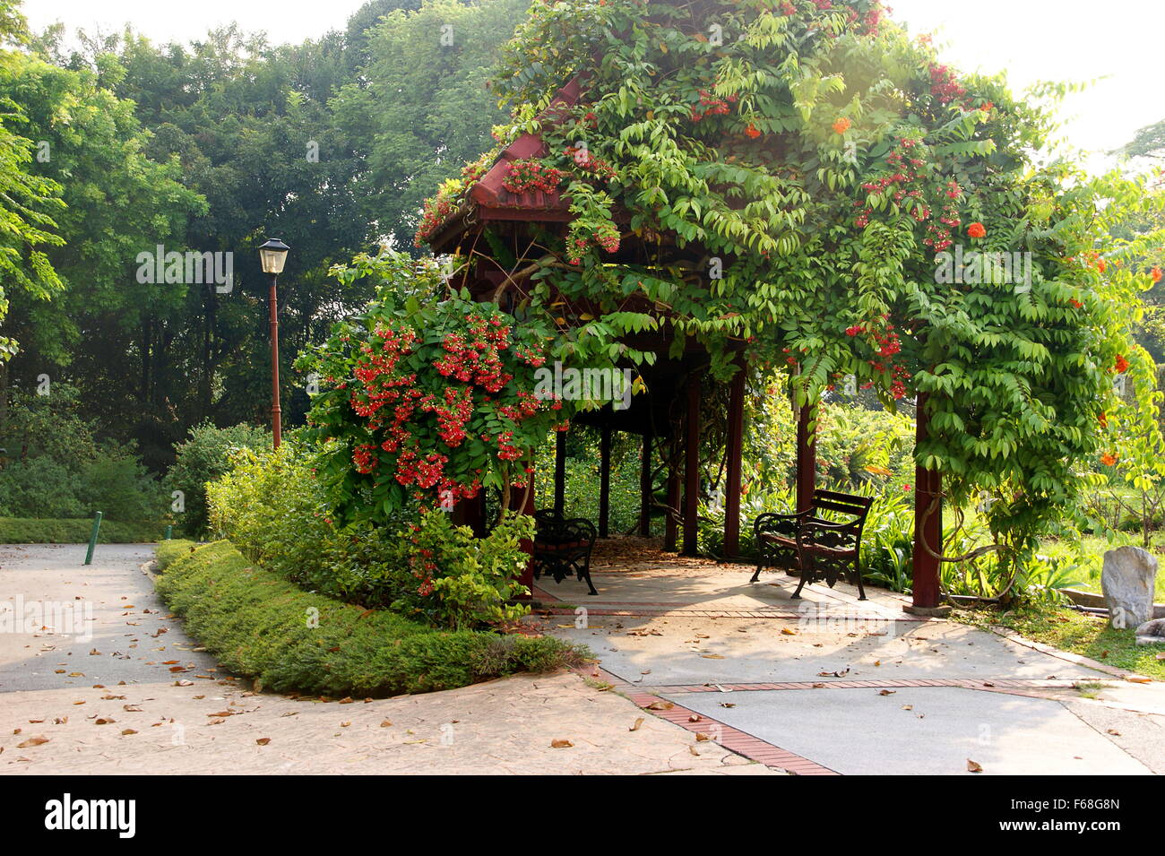 Gazebo overgrown with flowers Stock Photo - Alamy