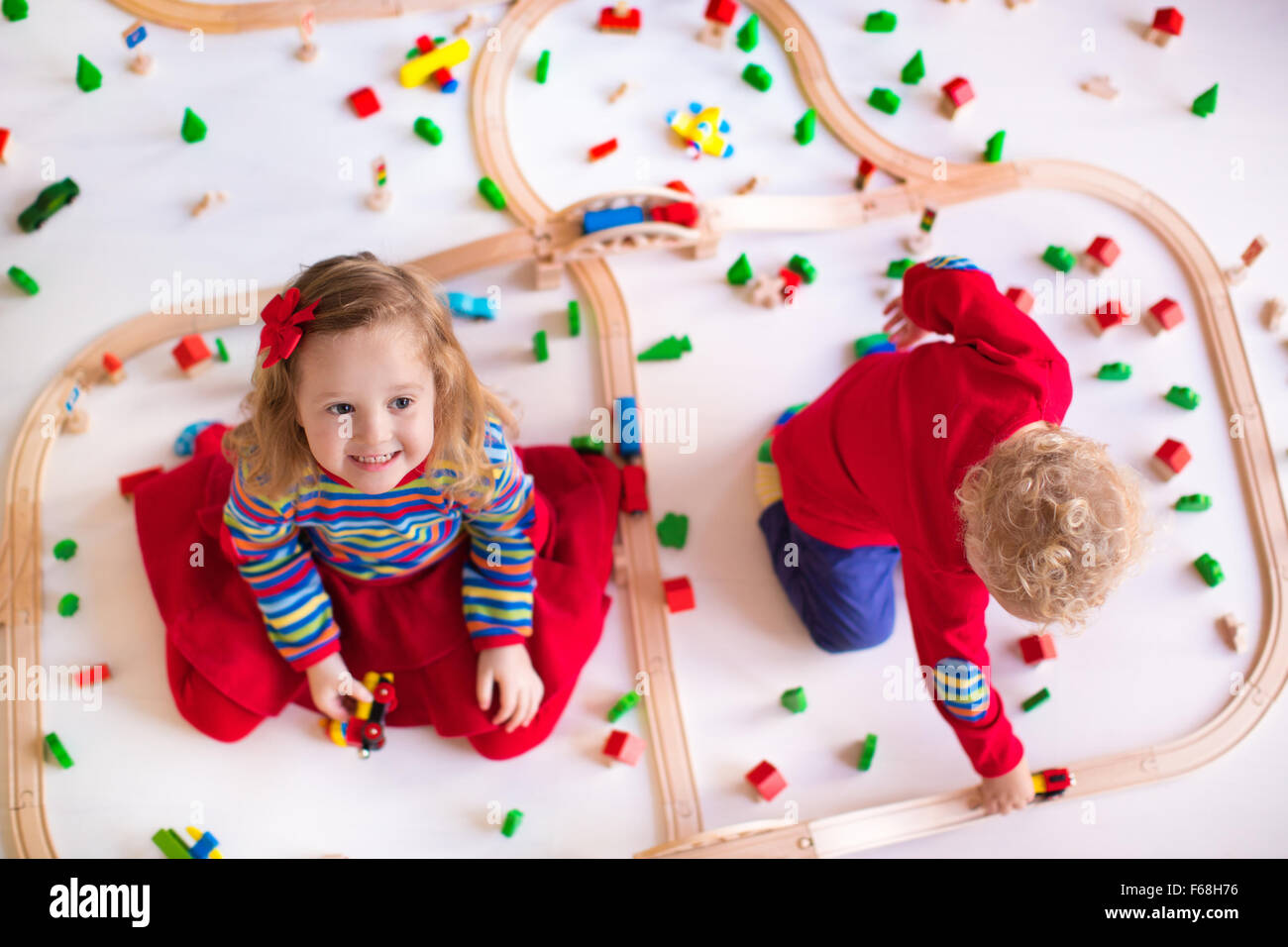 Children playing with wooden train. Toy railroad. Toddler kid and baby ...