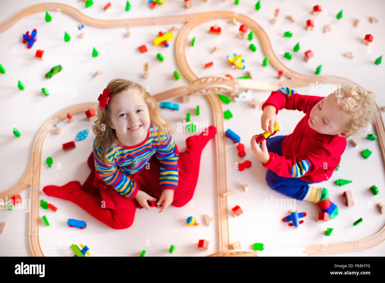Children playing with wooden train. Toy railroad. Toddler kid and baby ...