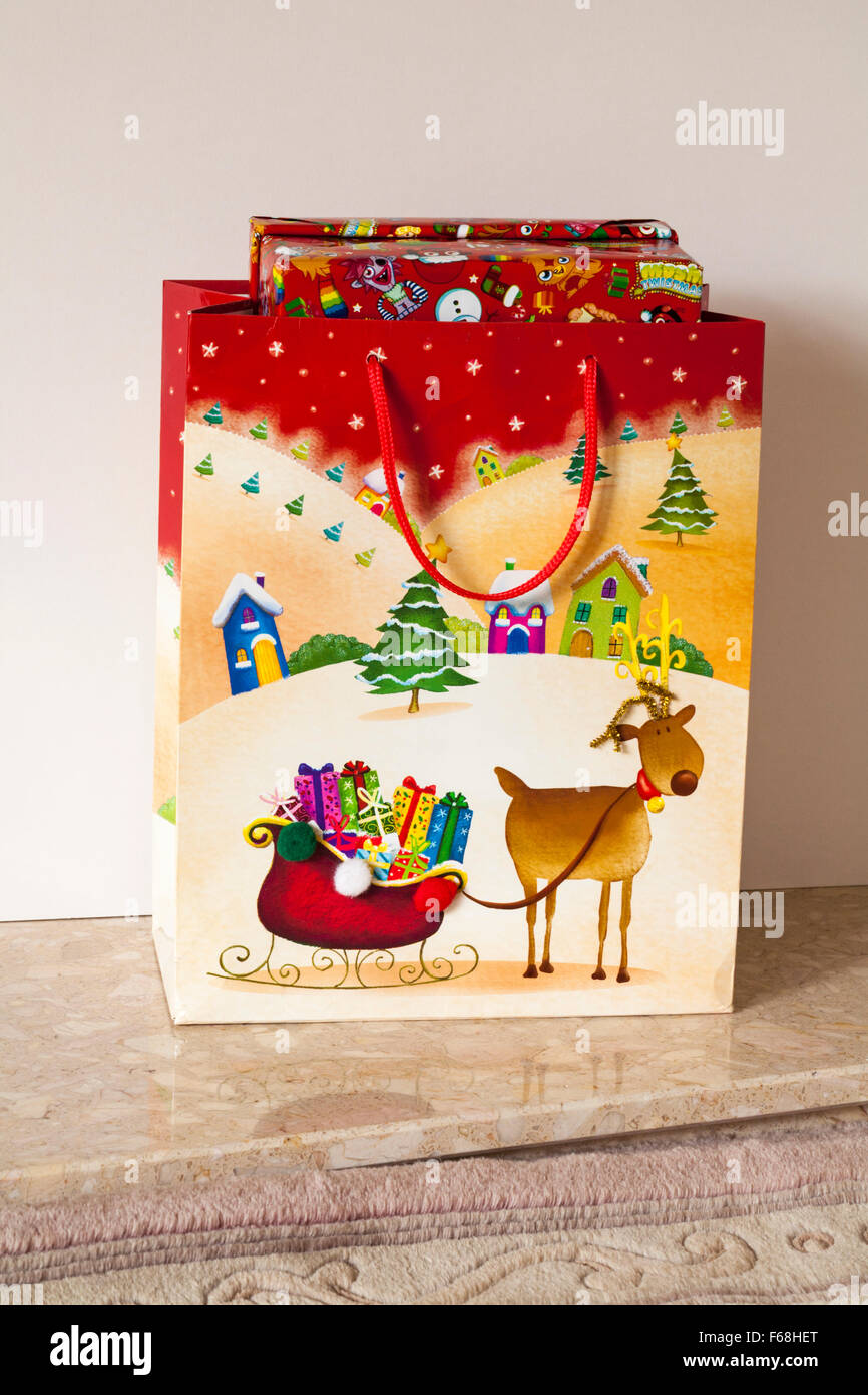 Christmas decorative gift bag with wrapped Christmas presents inside ...