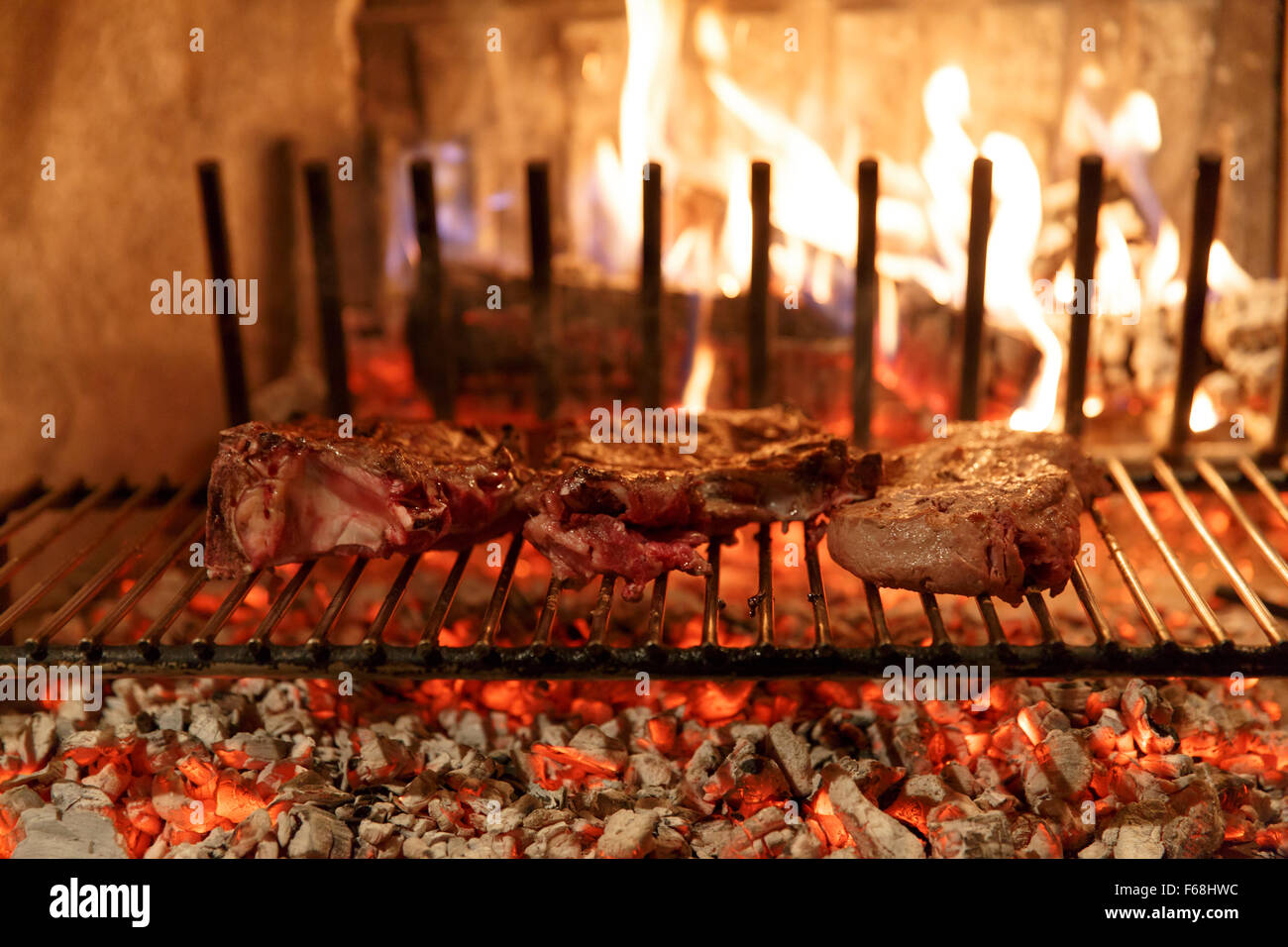 A top sirloin steak flame broiled on a barbecue, shallow depth of field ...