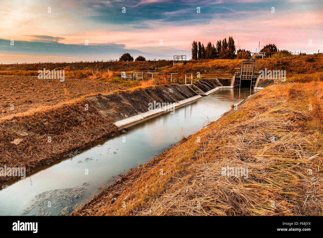 Channel to divert river water for irrigation of cultivated fields Stock ...
