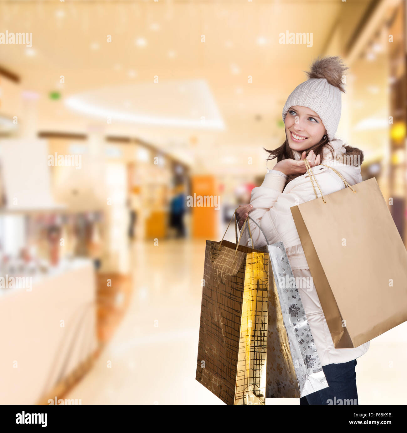 Happy brunette girl in shopping mall Stock Photo - Alamy
