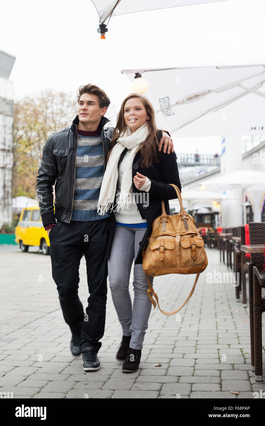 Couple Walking Together On Sidewalk Stock Photo - Alamy