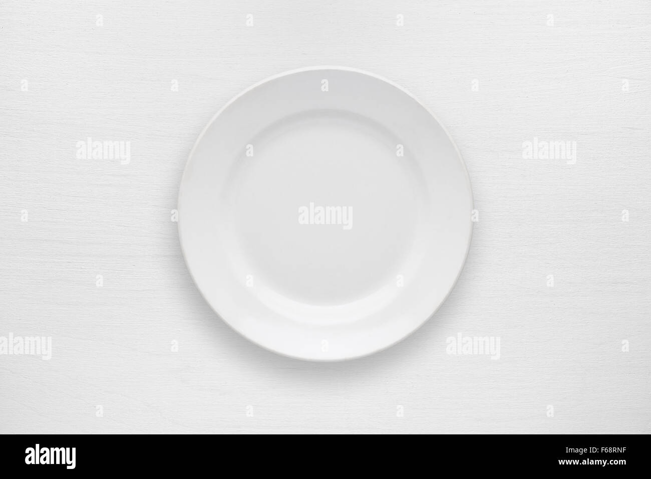 Empty plate on white table top view Stock Photo - Alamy