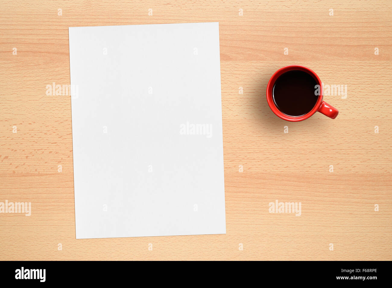 Blank sheet of paper and coffee cup on table Stock Photo - Alamy