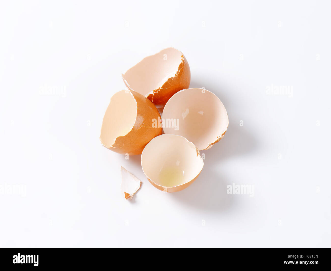 Empty brown egg shells on white background Stock Photo - Alamy