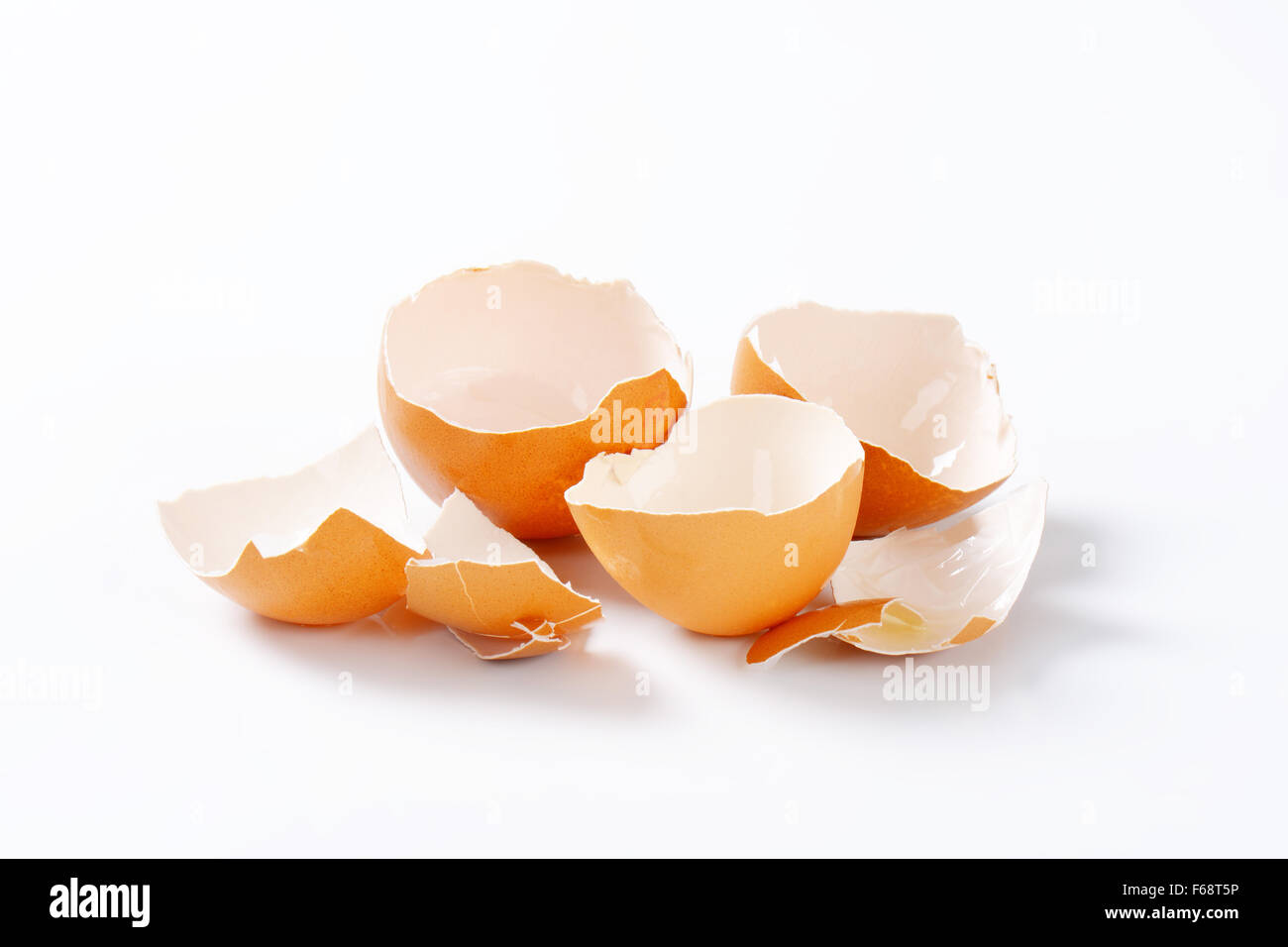 Empty brown egg shells on white background Stock Photo - Alamy
