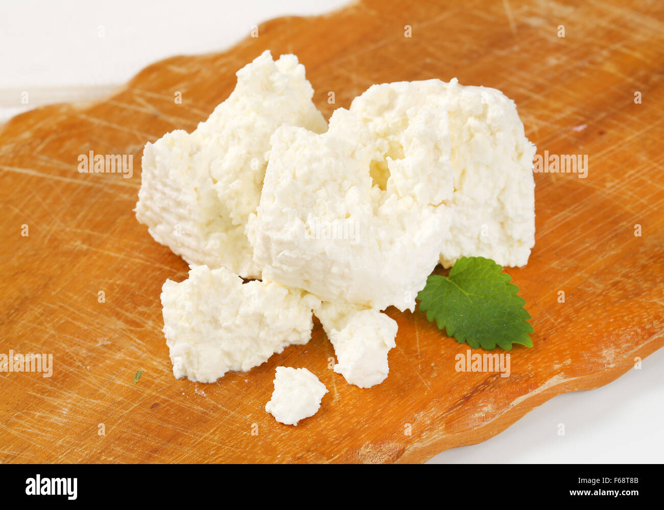 slices of fresh curd cheese on wooden cutting board Stock Photo - Alamy