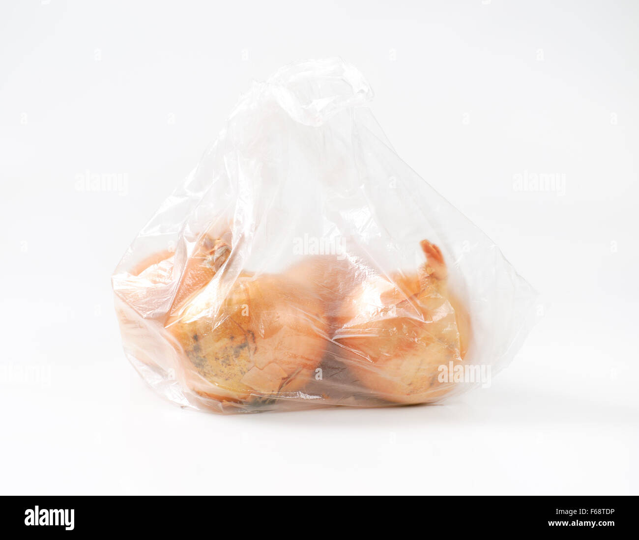 raw onions in transparent plastic bag on white background Stock Photo ...