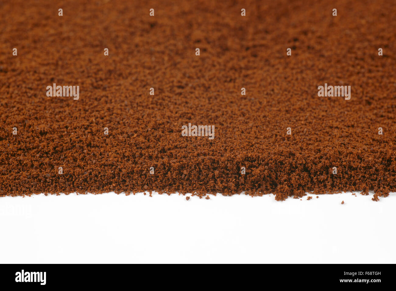 close up of freshly ground coffee on white background Stock Photo - Alamy