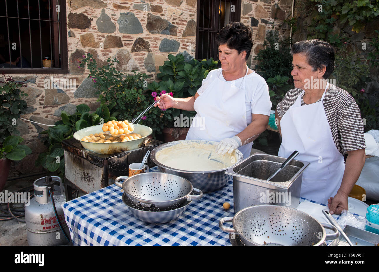 Women preparing and cooking homemade traditional delicious greek ...