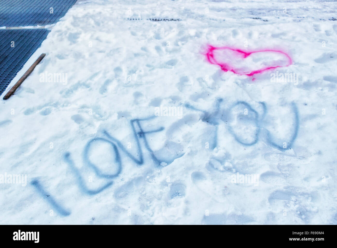 I love you, written in capital letters on frozen white snow with drawn ...