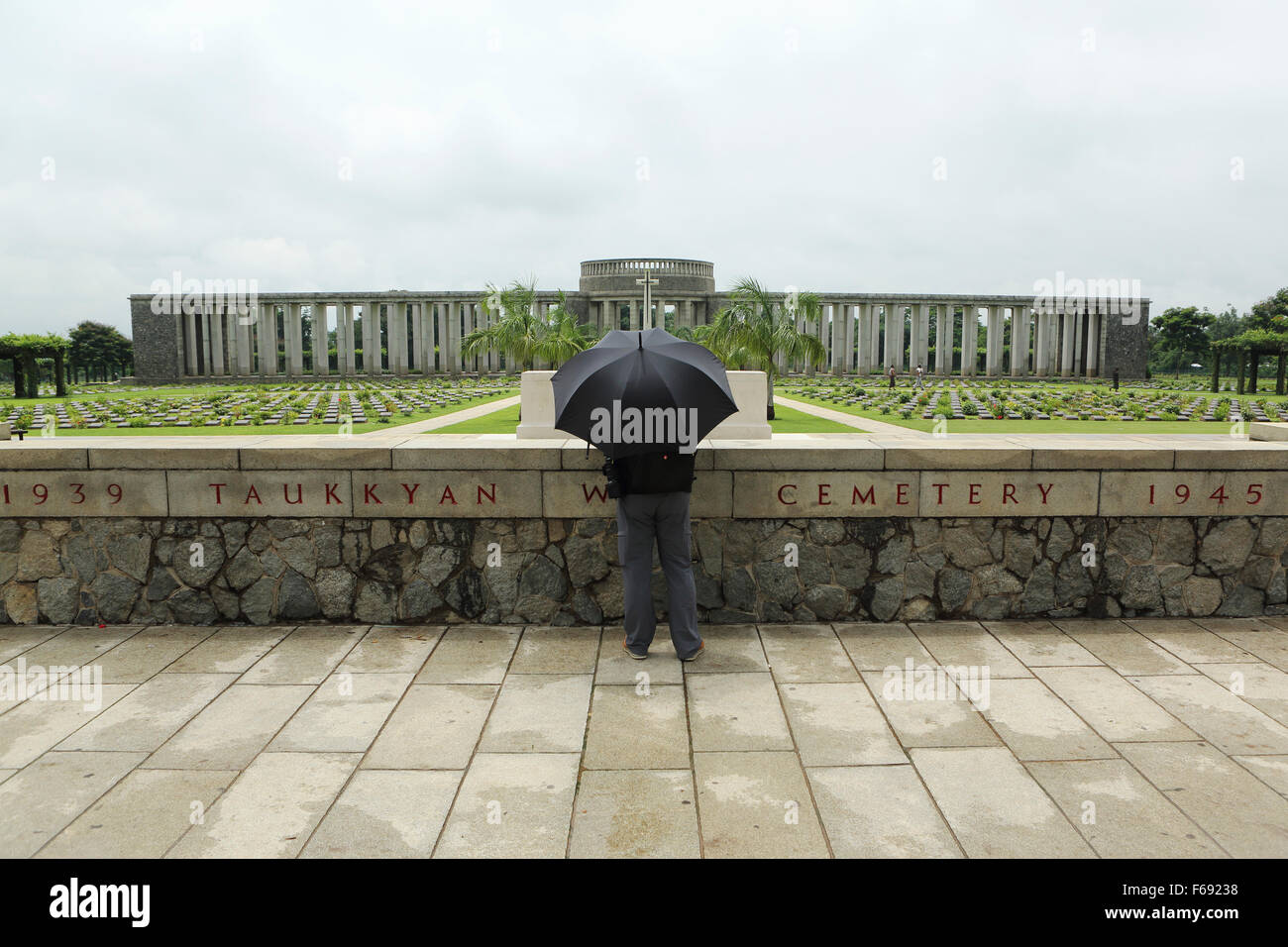 A man looks towards the Rangoon Memorial at Taukkyan War Cemetery near ...