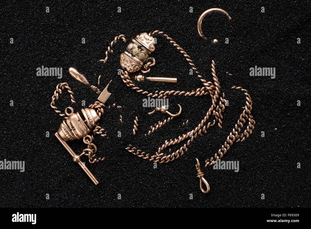 Ancient golden chains in sand.Wealth, vanity and obsolete concept Stock ...