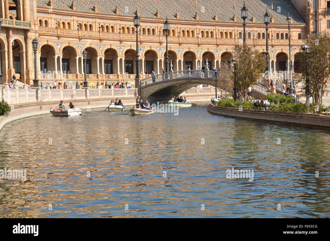 People rowing in small boats in the pond of Spain Square in Seville ...