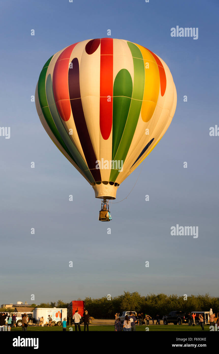 A single balloon floats over the field below Stock Photo - Alamy