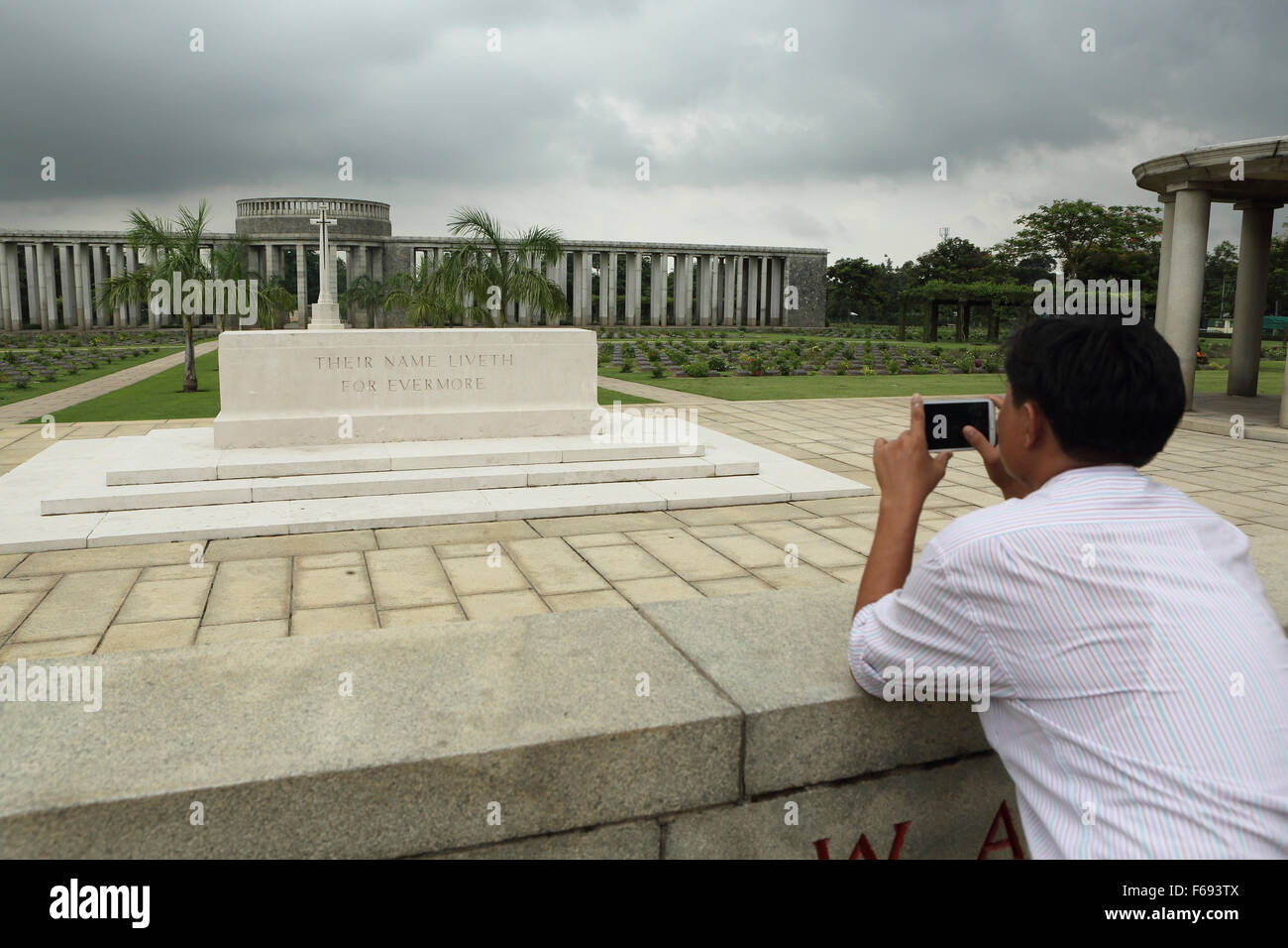 A man photographs the Rangoon Memorial at Taukkyan War Cemetery near ...