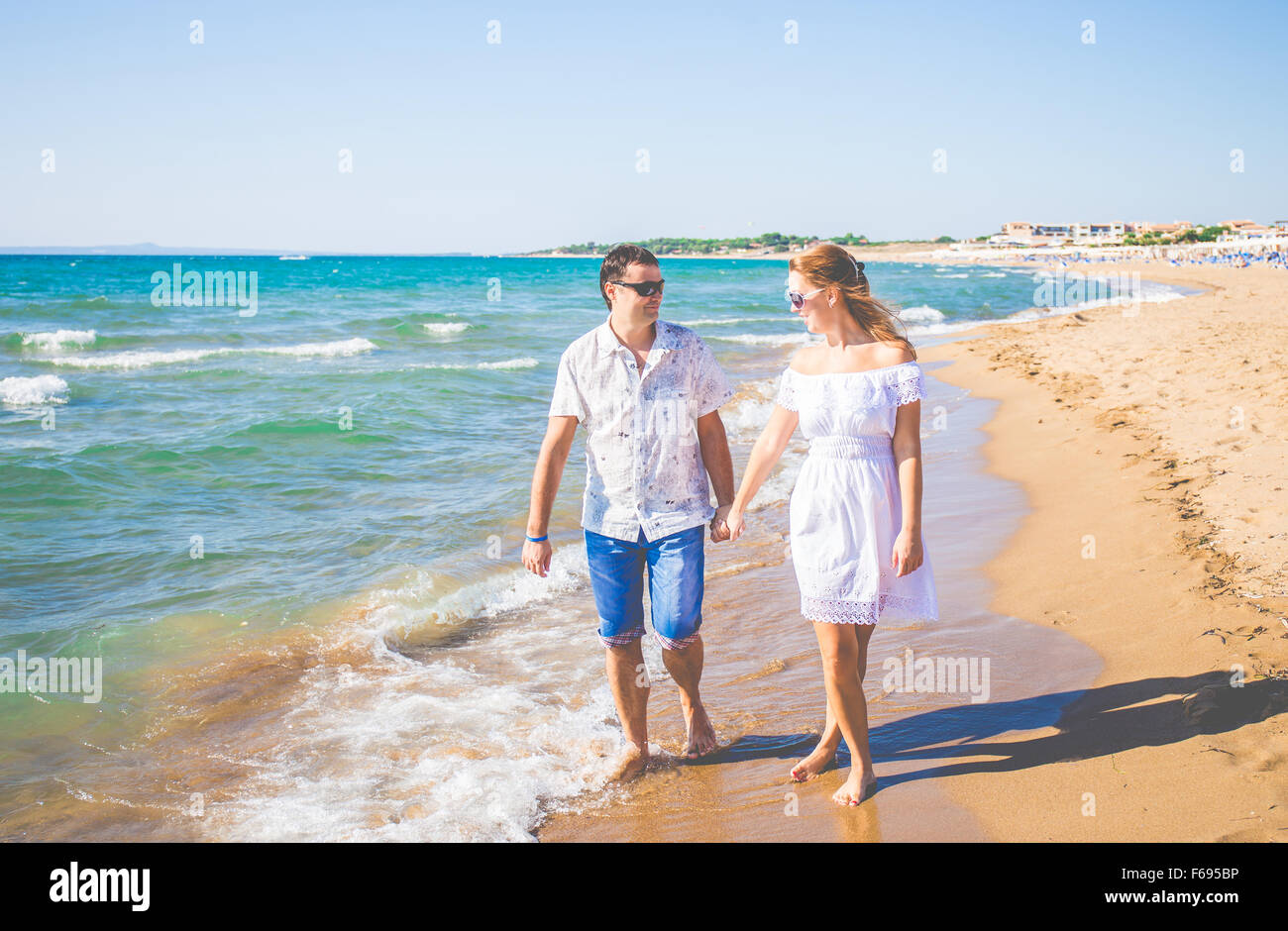 enamored couple posing on a beach Stock Photo - Alamy